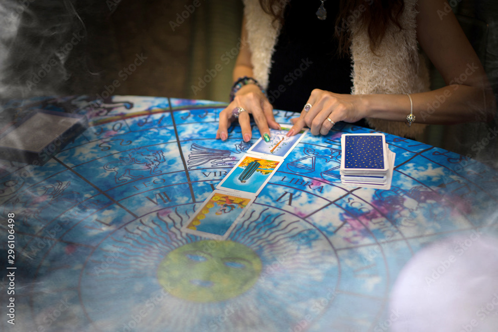 The fortune teller is using cards and crystal glass balls to see the ...
