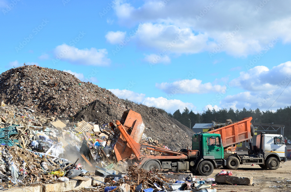 Garbage truck unloads construction waste from container at the landfill ...