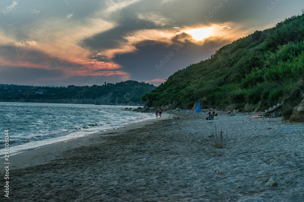 Cloudy sunset view with orange colors at Kanali beach near Lourdata ...