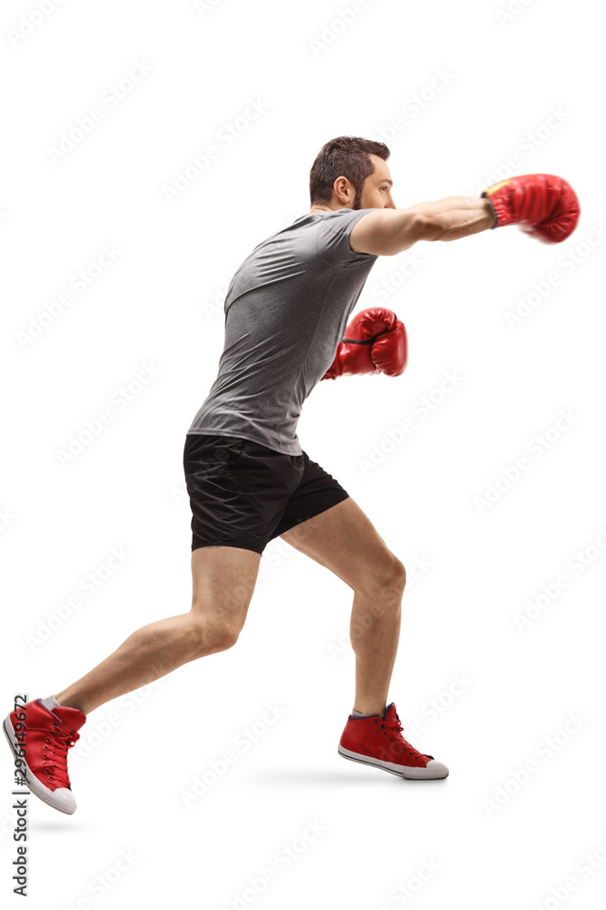 Young guy punching with boxing gloves Stock Photo | Adobe Stock
