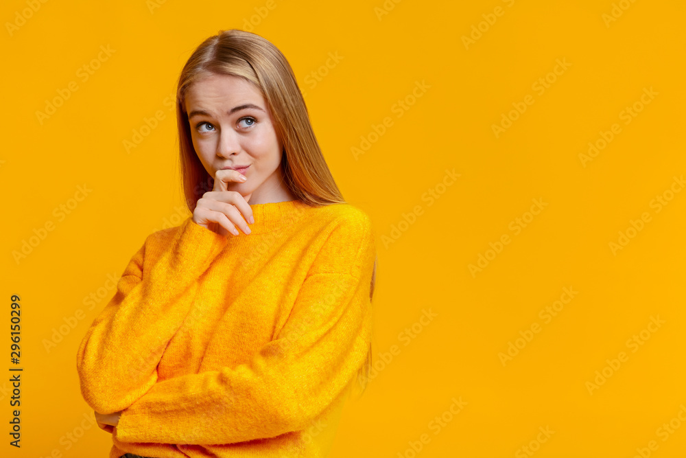 Portrait of doubtful teenage girl over orange background Stock Photo ...