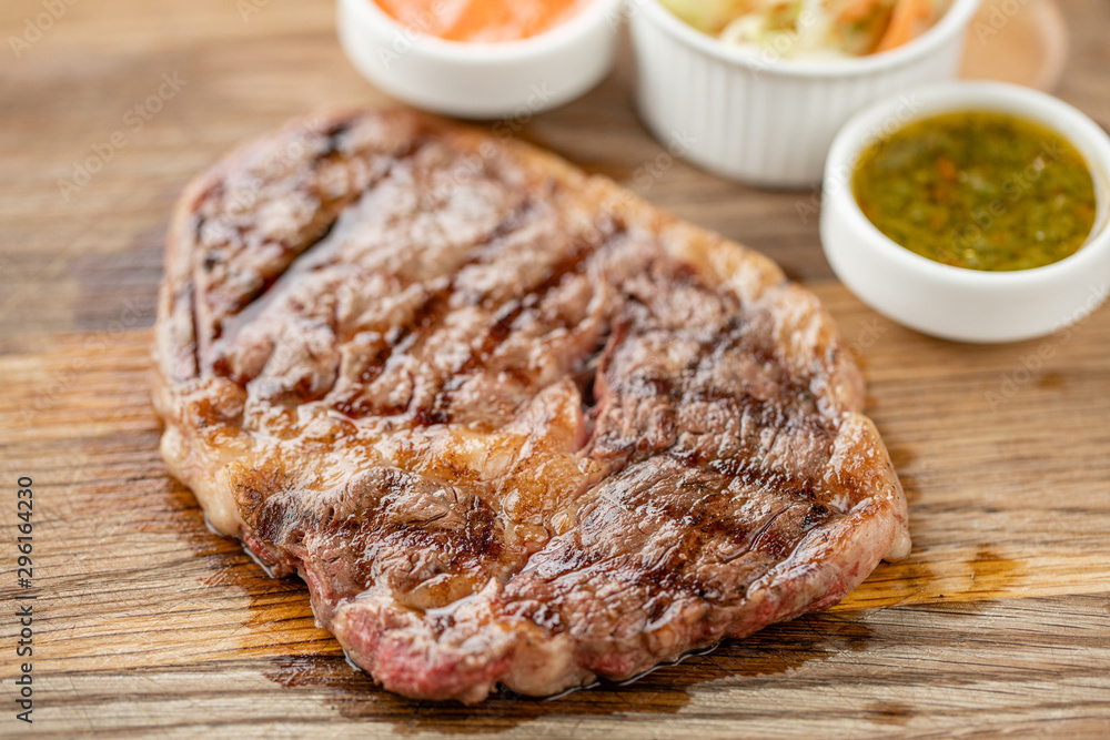 Sliced medium rare grilled Steak Ribeye with Pickled cabbage and two ...