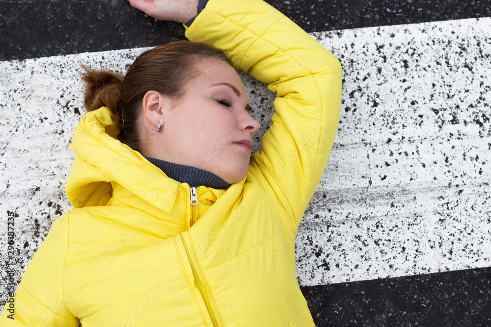 Young unconscious woman at accident scene, crash on the road. Pedestrian girl hit by a car on ...