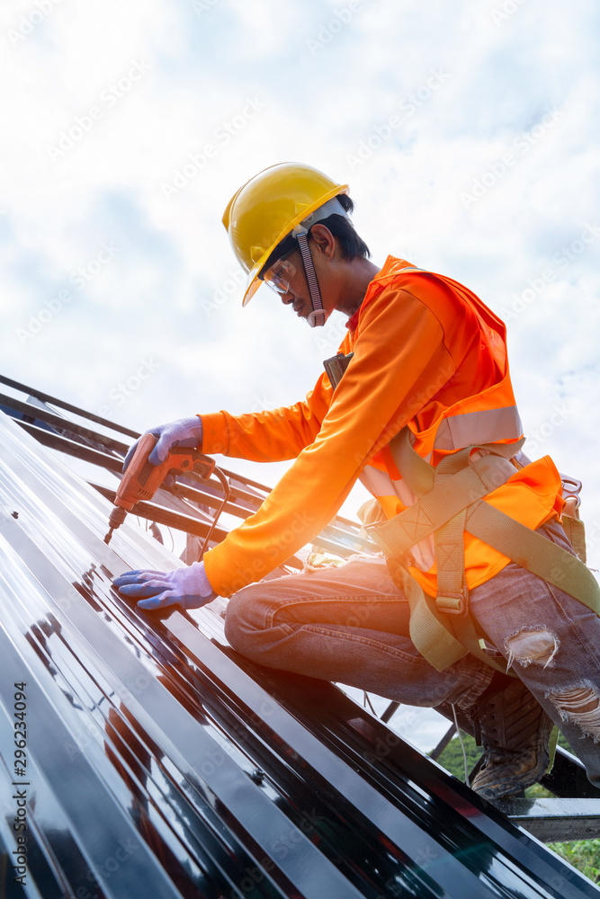 Foto de Roofer worker in protective uniform wear and gloves, using air ...