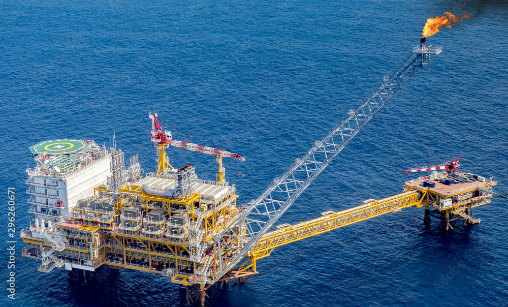 Offshore oil and gas platforms are in the process of releasing gas to ...