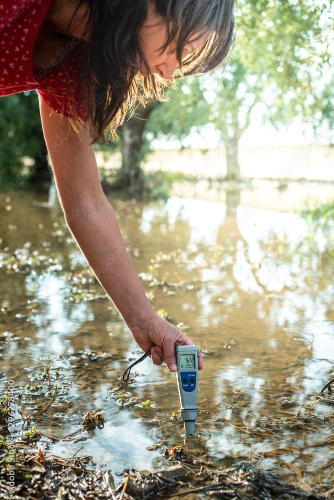 Measure water content with digital device. PH meter. Stock Photo ...