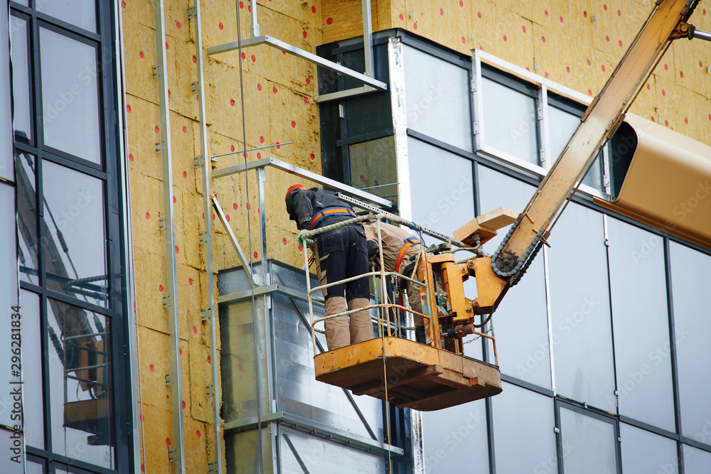 Workers on height install ventilation ducts. Professional industrial ...