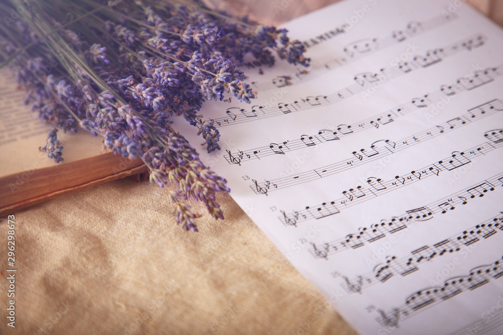 Lavender and paper music notes on old fabric background in vintage ...