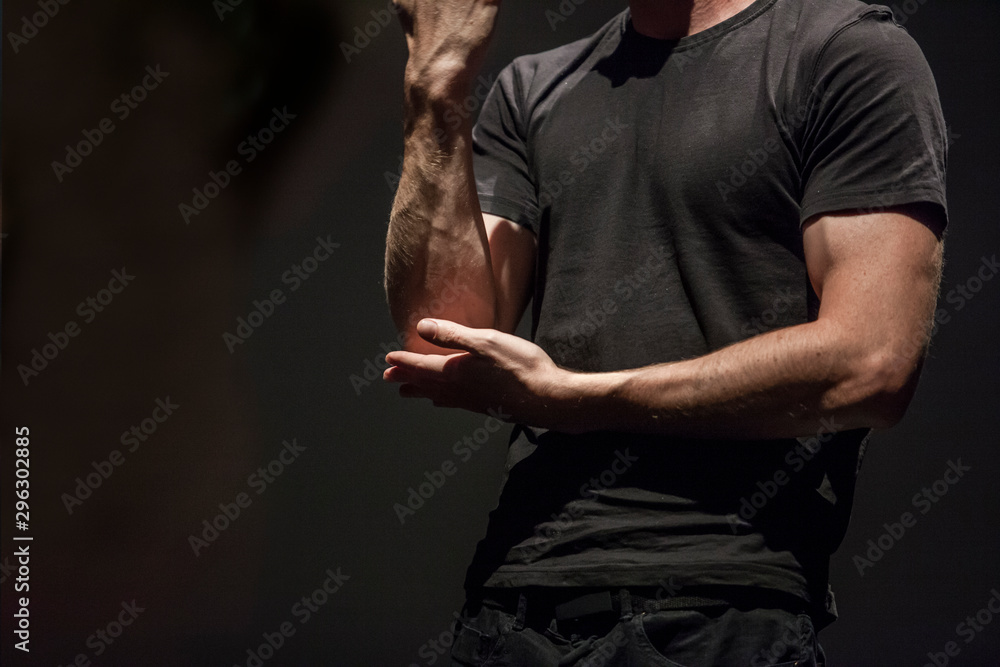 Sign language man interpreter gestures over stage during public event ...