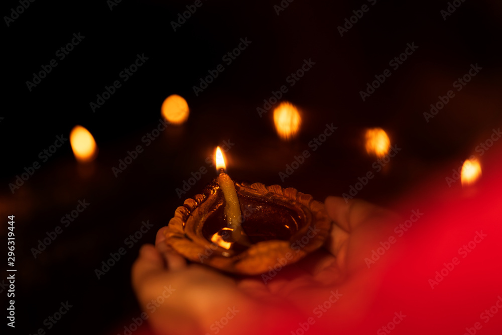 Person Hand Holding Diya on Diwali. Indian woman or female holding diya ...