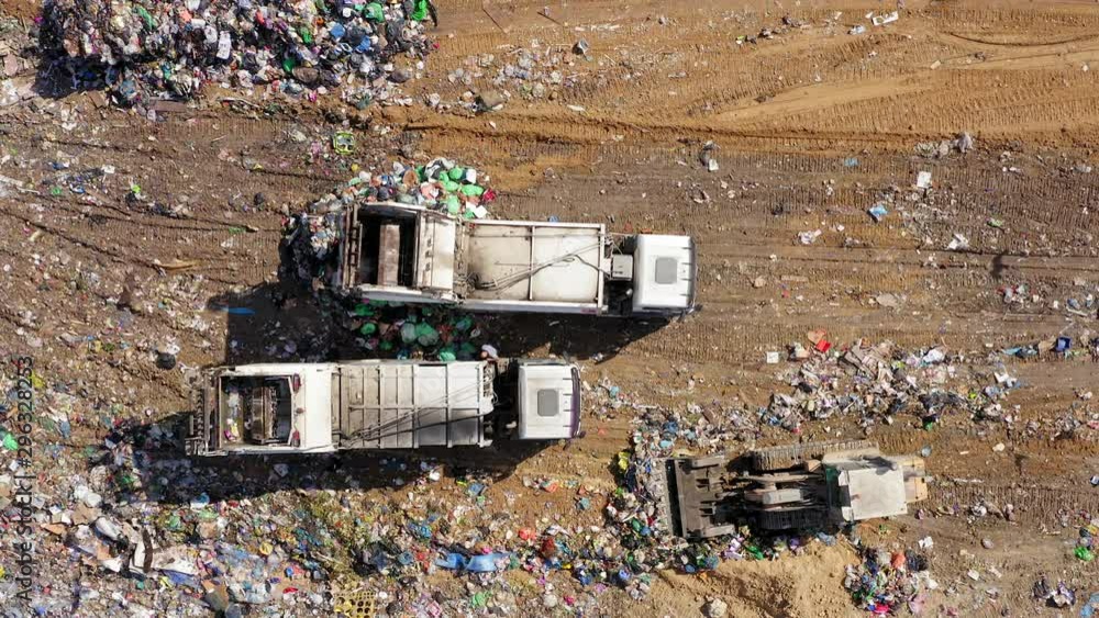 Loaded Garbage Truck unloading at a Municipal landfill, Top down aerial ...