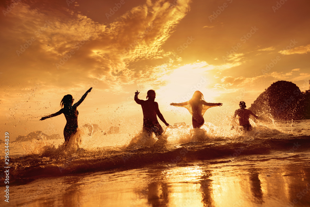 Happy friends run and having fun at sunset beach Stock Photo | Adobe Stock