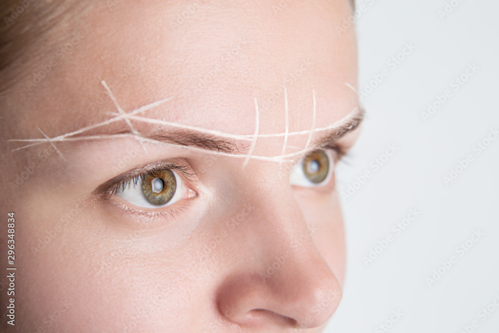 Brow marking and measuring before microblading or henna tattoo close-up ...