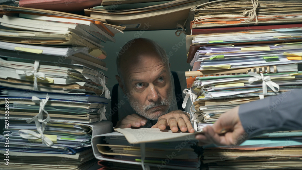 Creepy office clerk overloaded with paperwork Stock Photo | Adobe Stock