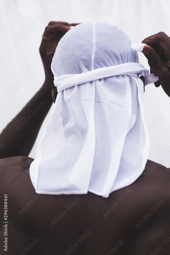 Rear view of shirtless model with headscarf Stock Photo | Adobe Stock
