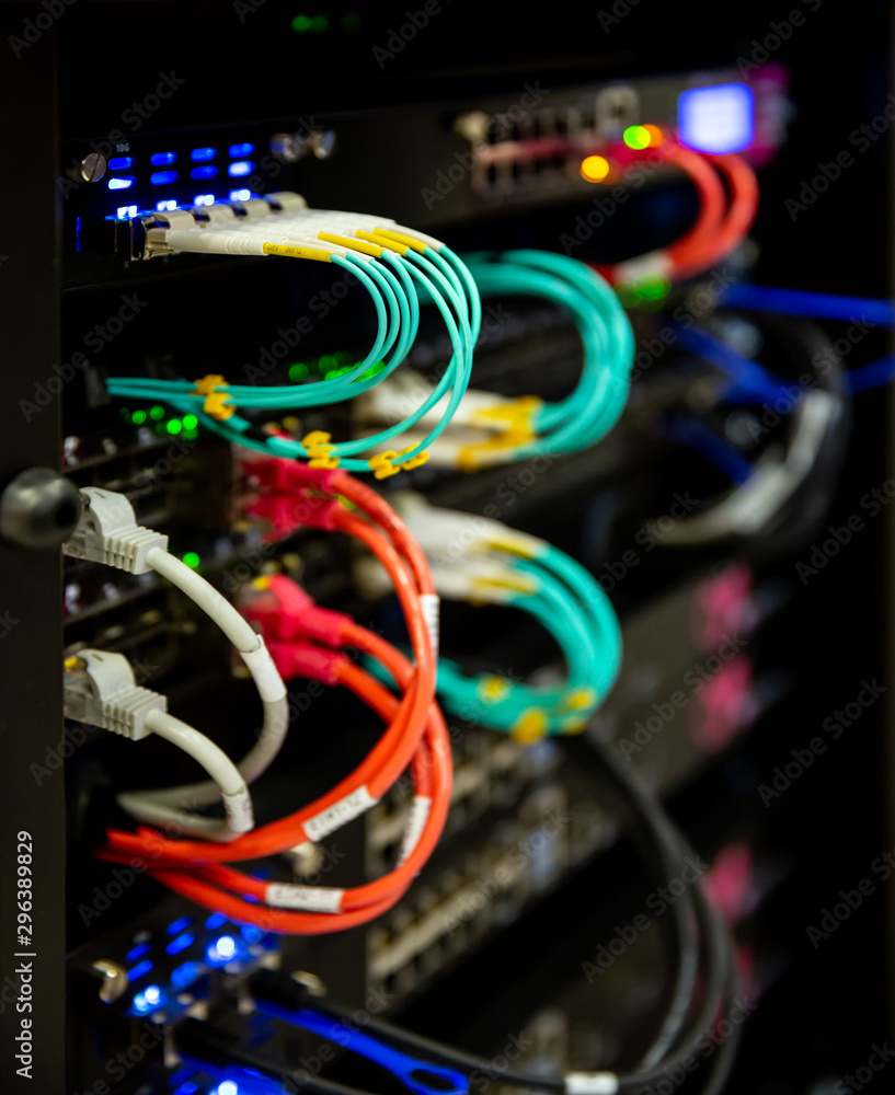 Server rack with internet cord cables, connected to patch panel in data ...