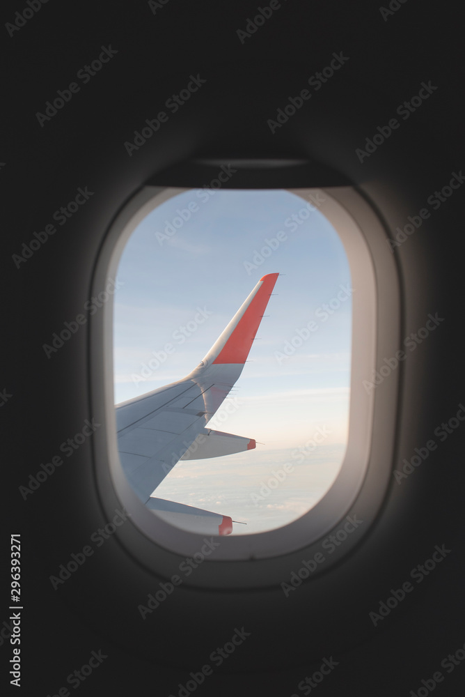 View from inside airplane window. Looking outside at the airplane wing ...