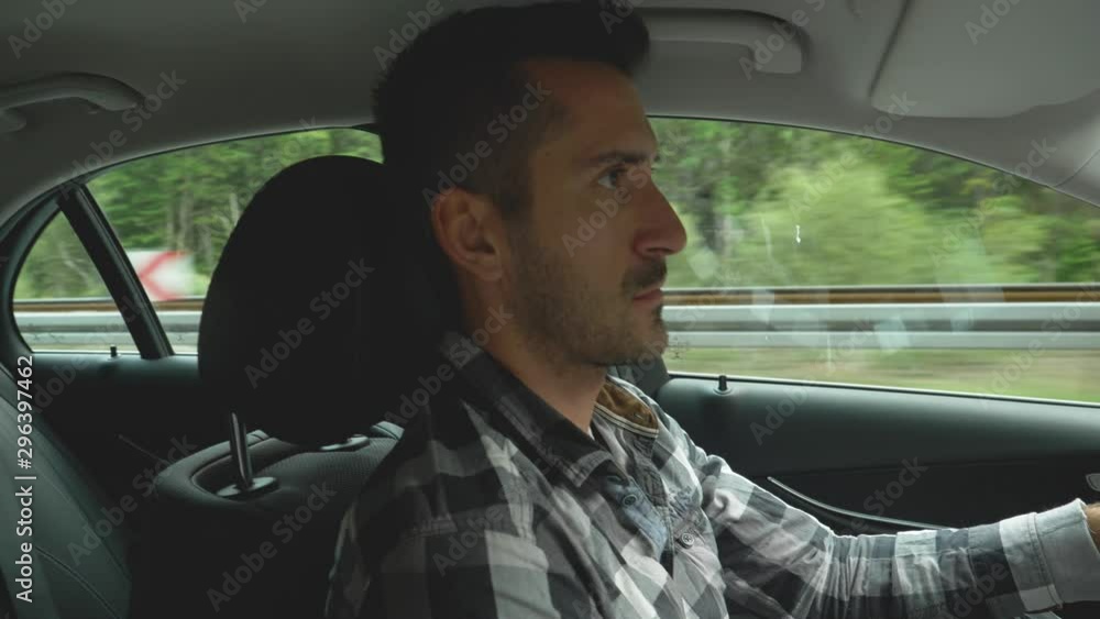 Angry man driver shows middle finger, road rage, profile interior shot ...