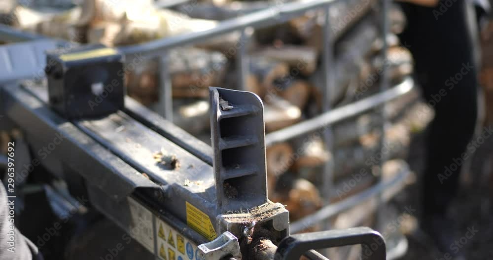 Static close up, Wooden log splits in half, Wood cutting machine chops ...