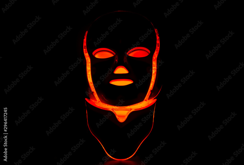 Color therapy mask glowing red dark background Stock Photo | Adobe Stock