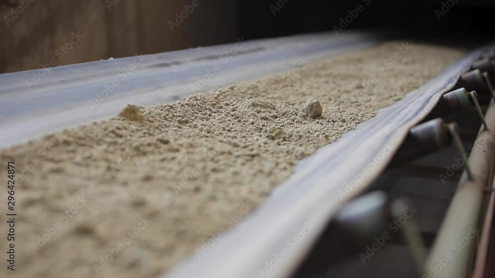 Machines working and conveyor line transporting sand. Conveyor belt on ...