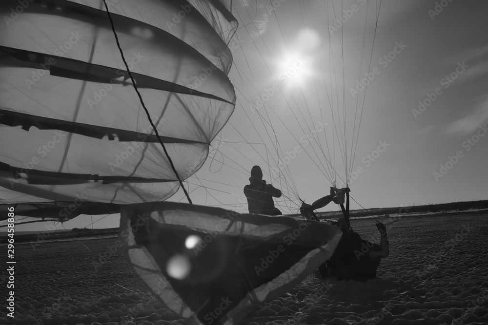 Part of the canopy and the slings of the parachute during landing ...