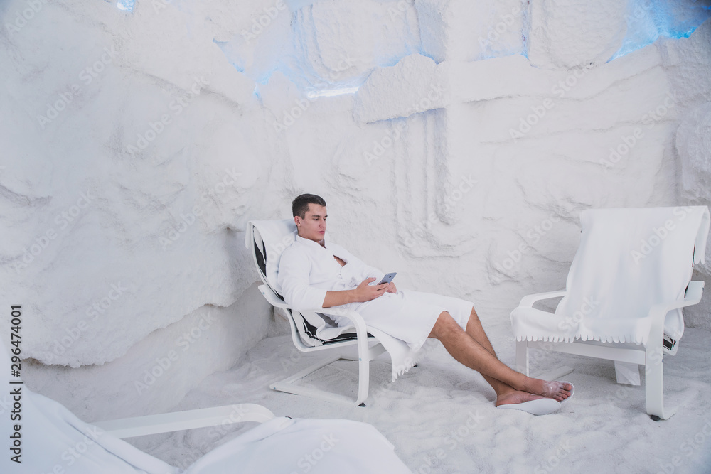 A young man is resting in the salt room, Spa treatments for men with ...