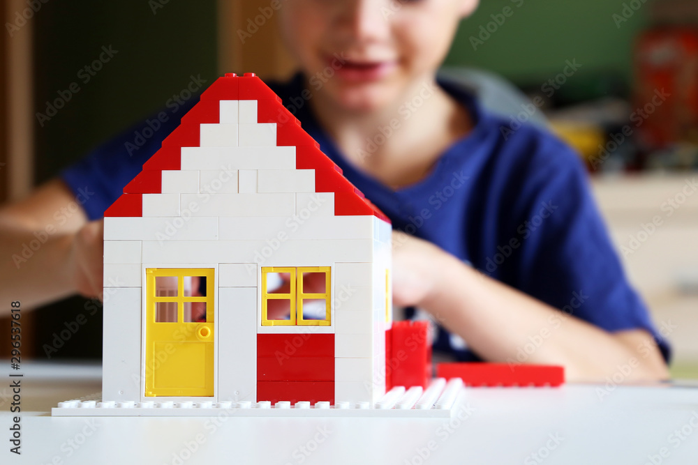 Boy builds his dream house with building blocks Stock Photo | Adobe Stock