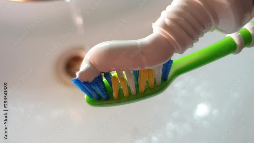 Squeezing toothpaste onto a toothbrush. Stock Video | Adobe Stock