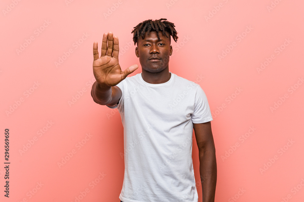 Young african black man standing with outstretched hand showing stop ...