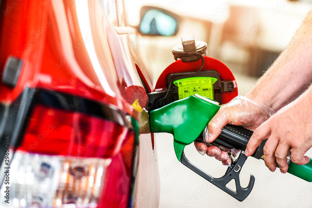 Man holding pump and refueling gasoline at gas station.Petrol filling ...