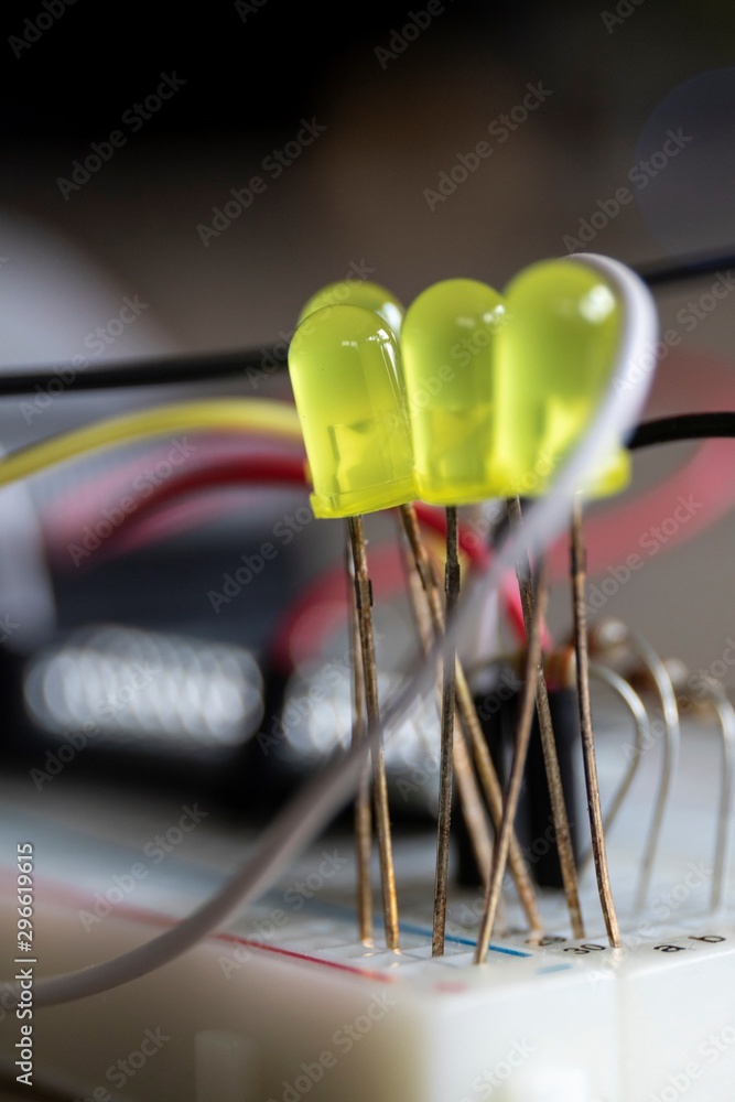 A portrait of LEDS wired into a breadboard creating an electronic ...