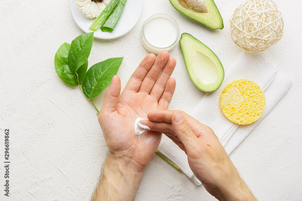 man hand care and smear moisturizing cream. spa treatments for modern ...