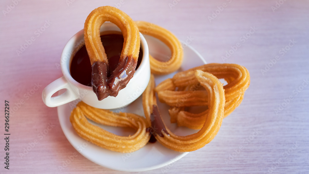 Churros con chocolate caliente, a traditional Spanish street food, a ...
