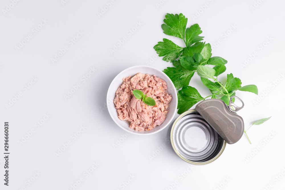 Canned tuna in a white bowl, isolated on white; empty open tuna tin on ...
