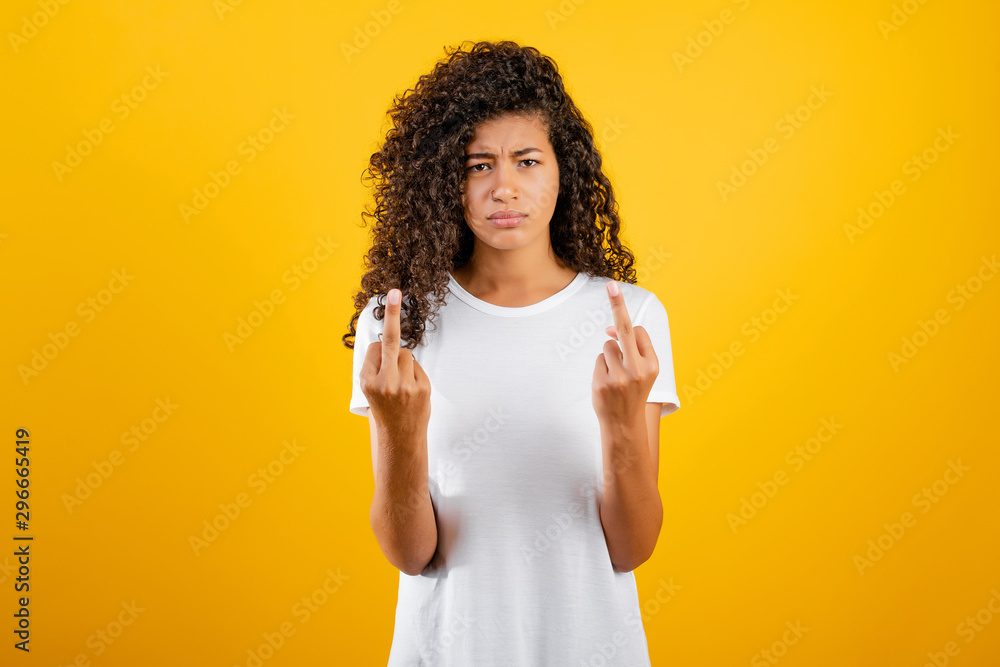 black african woman showing middle finger isolated over yellow Stock ...