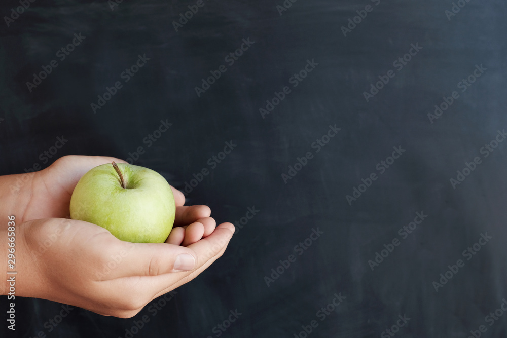Student hands holding green apple with blackboard background, Happy ...