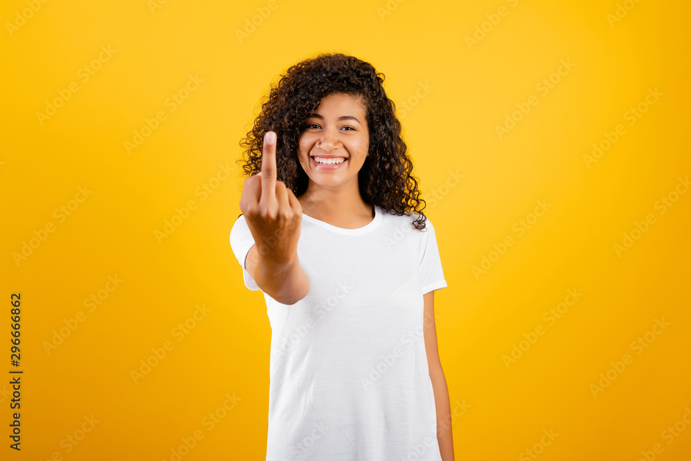 black african woman showing middle finger isolated over yellow Stock ...