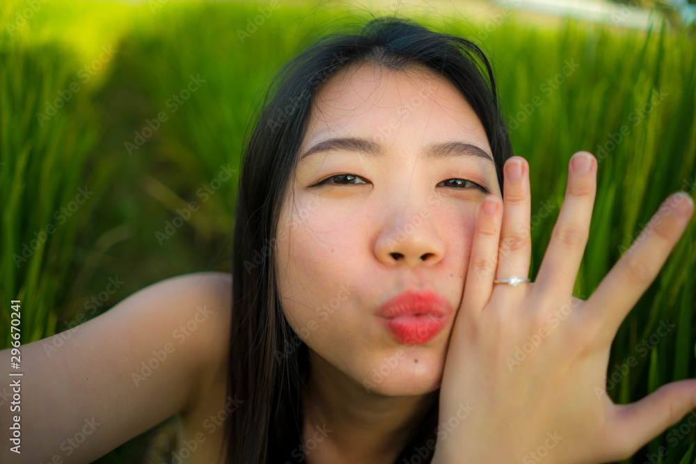 Young Happy And Beautiful Asian Woman Taking Selfie Photo Outdoors