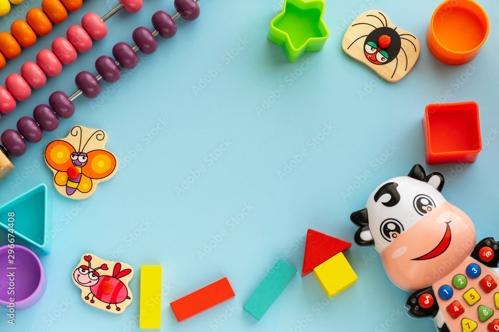 Top view children's educational games, frame kids toys on blue paper ...
