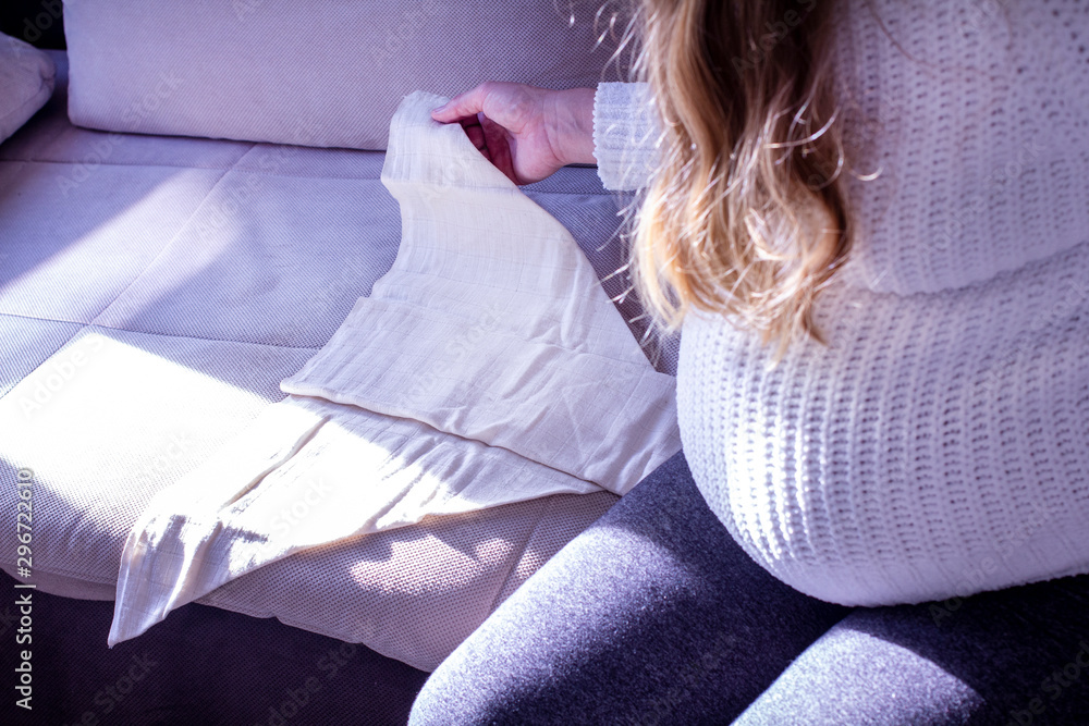 Sitting pregnant woman learns to fold a diaper for the baby. Cloth ...