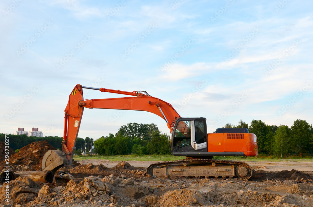 Excavator at a construction site during earthworks and laying of ...