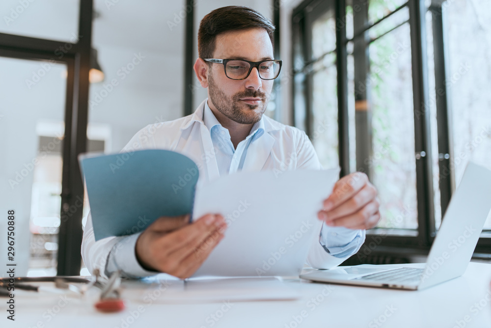 Close-up portrait of a doctor reading paper document. Stock Photo ...
