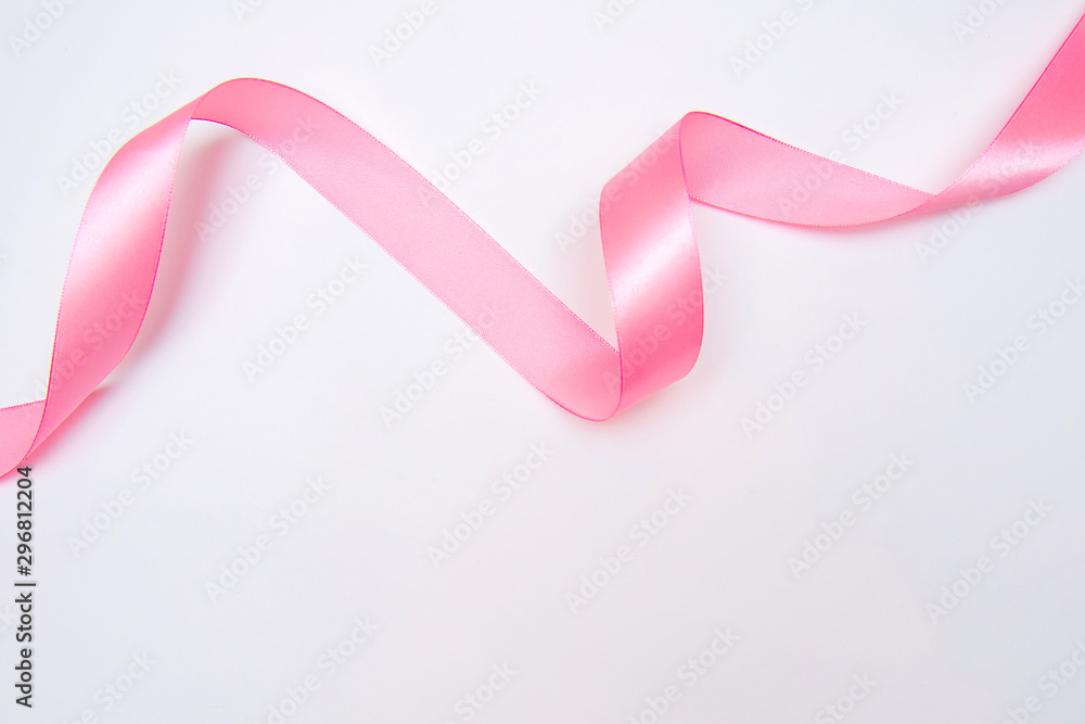 Curled pink ribbon with highlights isolated on white background, top ...
