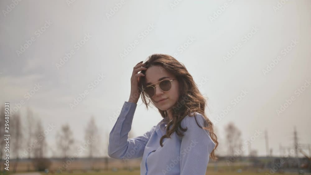 Beautiful 17 year old girl posing outdoors. Stock Video | Adobe Stock
