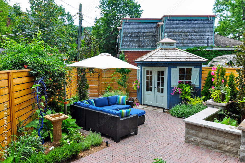 This beautiful small urban backyard garden features a herringbone ...