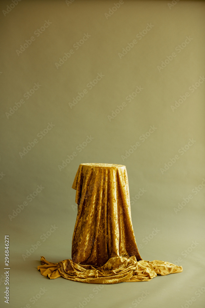 Gold velvet fabric draped over stool Stock Photo | Adobe Stock
