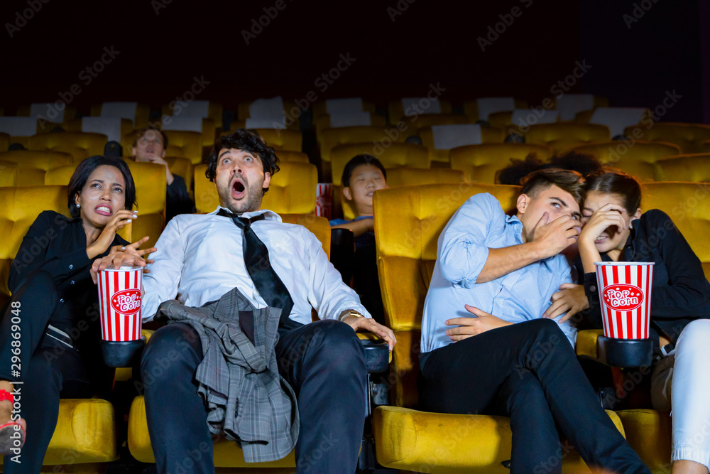 group of couple people watching movie feeling scary and frightening at ...