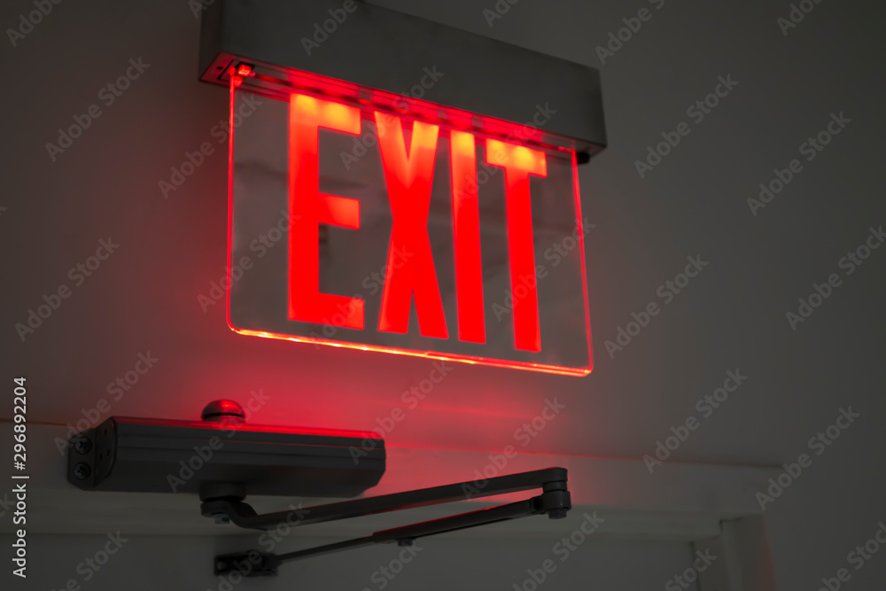 plexiglas red and yellow lighted exit sign over office doorway Stock ...