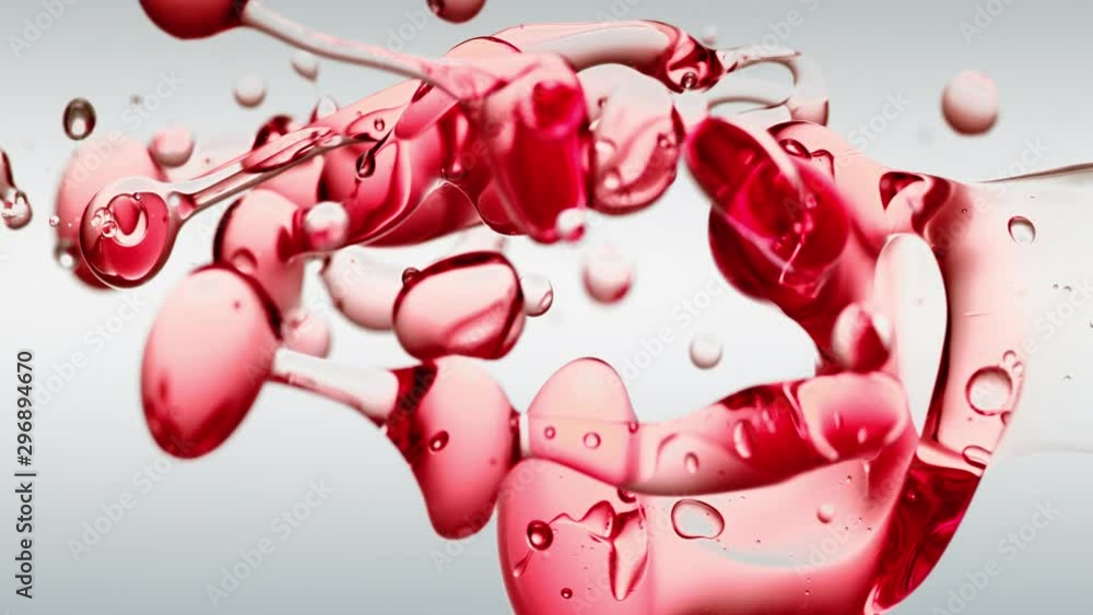 transparent red oil bubbles and fluid shapes in purified water on a ...